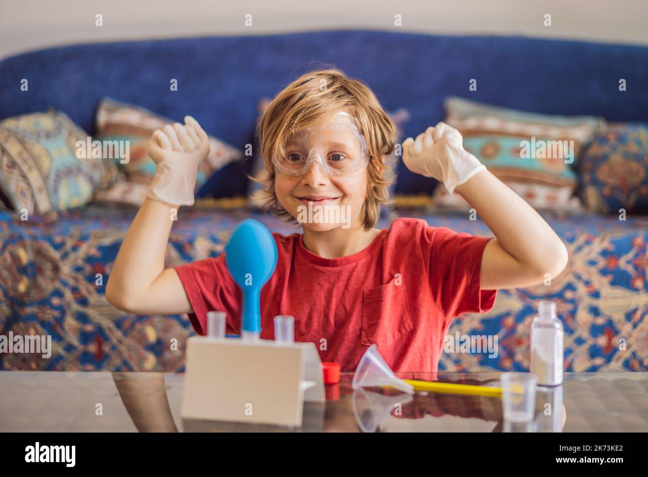 Kid boy doing chemical experiment at home. Child with protective ...