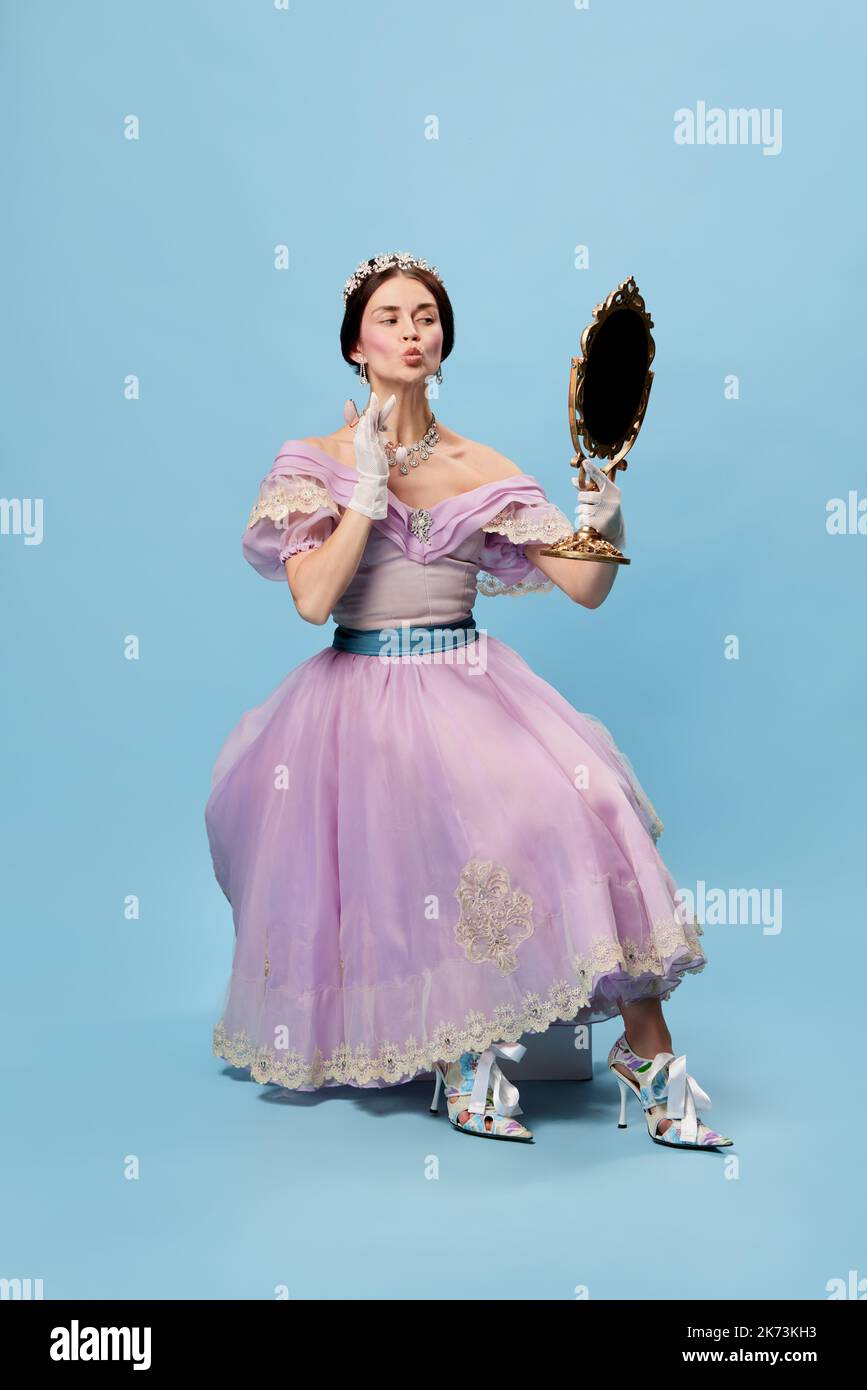 Self loving. Beautiful charming woman in lilac color vintage dress as a ...