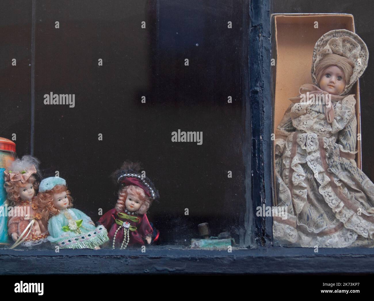 Dolls in the window of an antique shop Stock Photo - Alamy