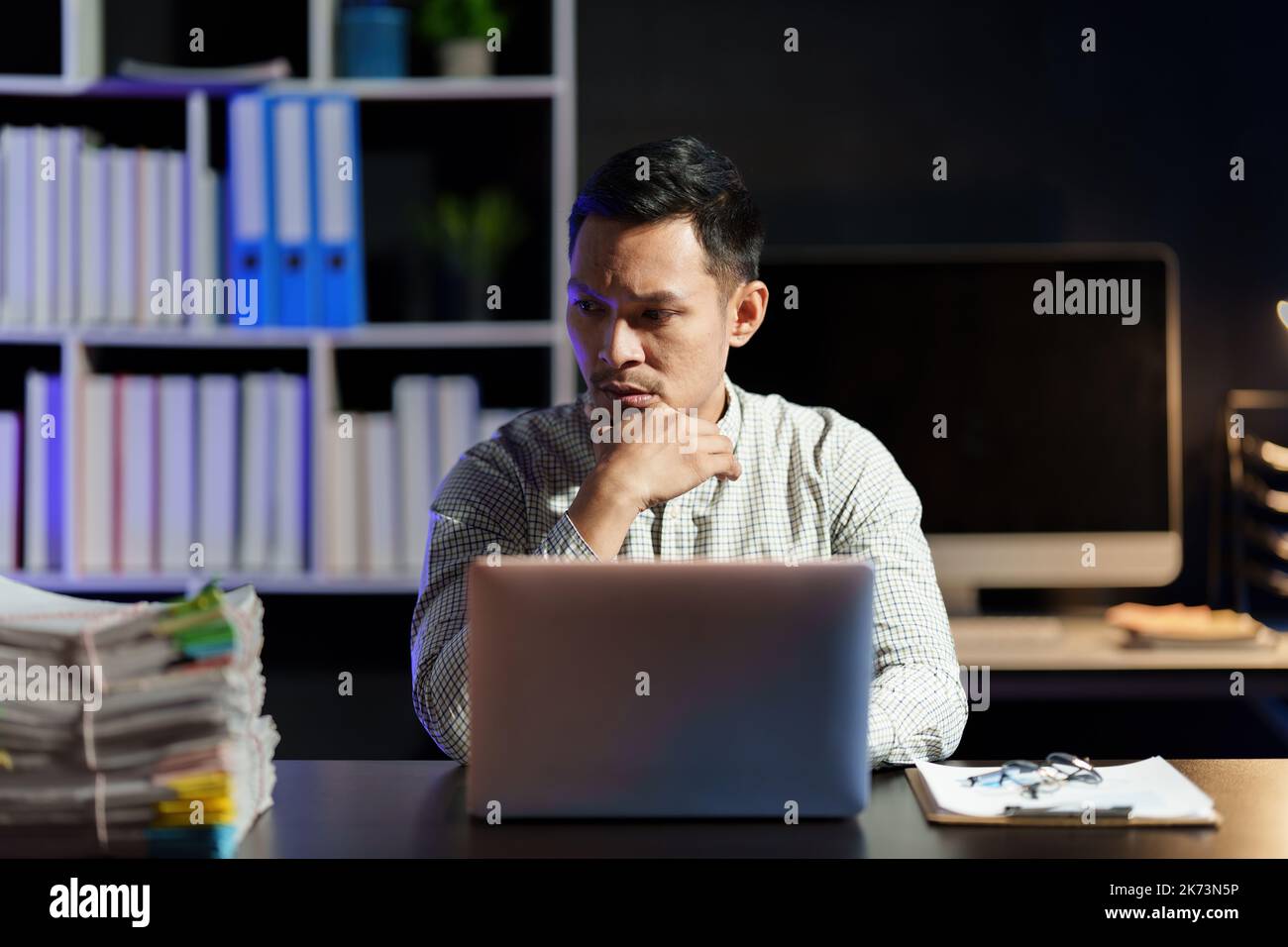 Stressed business man working over time at night. business account and ...