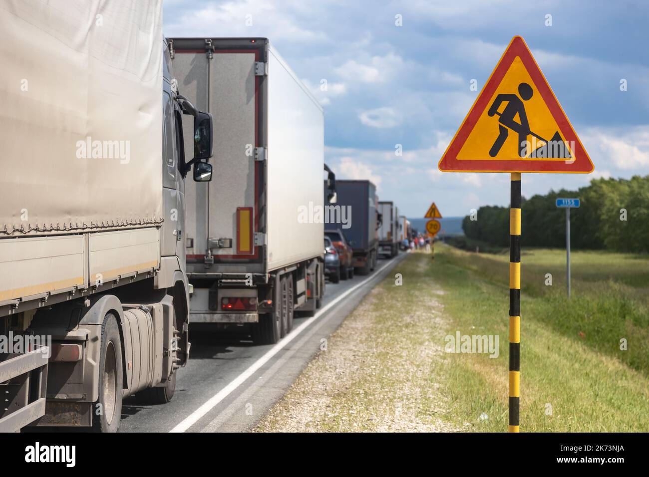 Trucks are stuck in traffic. A column of semi-trailers on the freeway ...