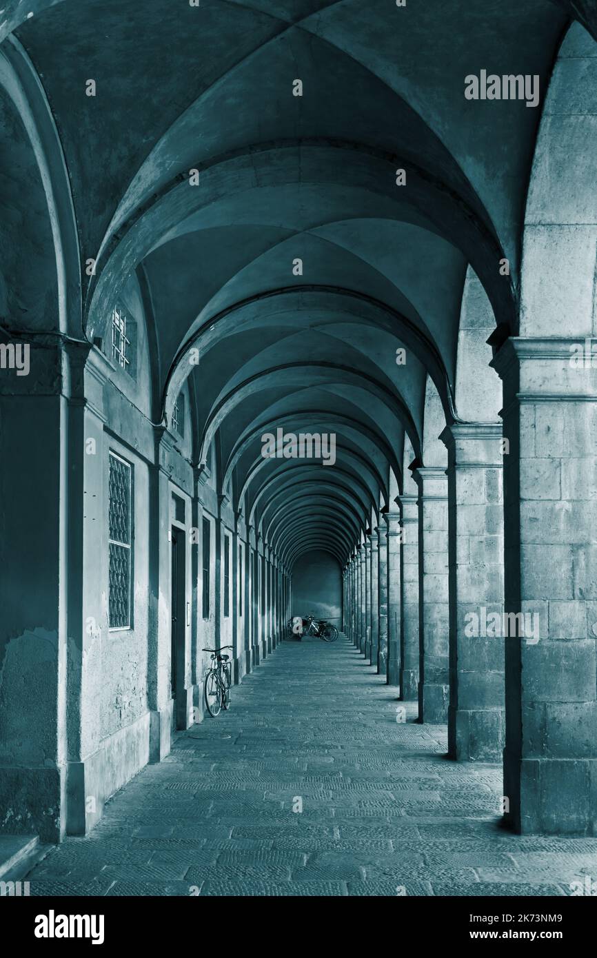 Arched passageway building in the town of Lucca, Italy dark teal color ...
