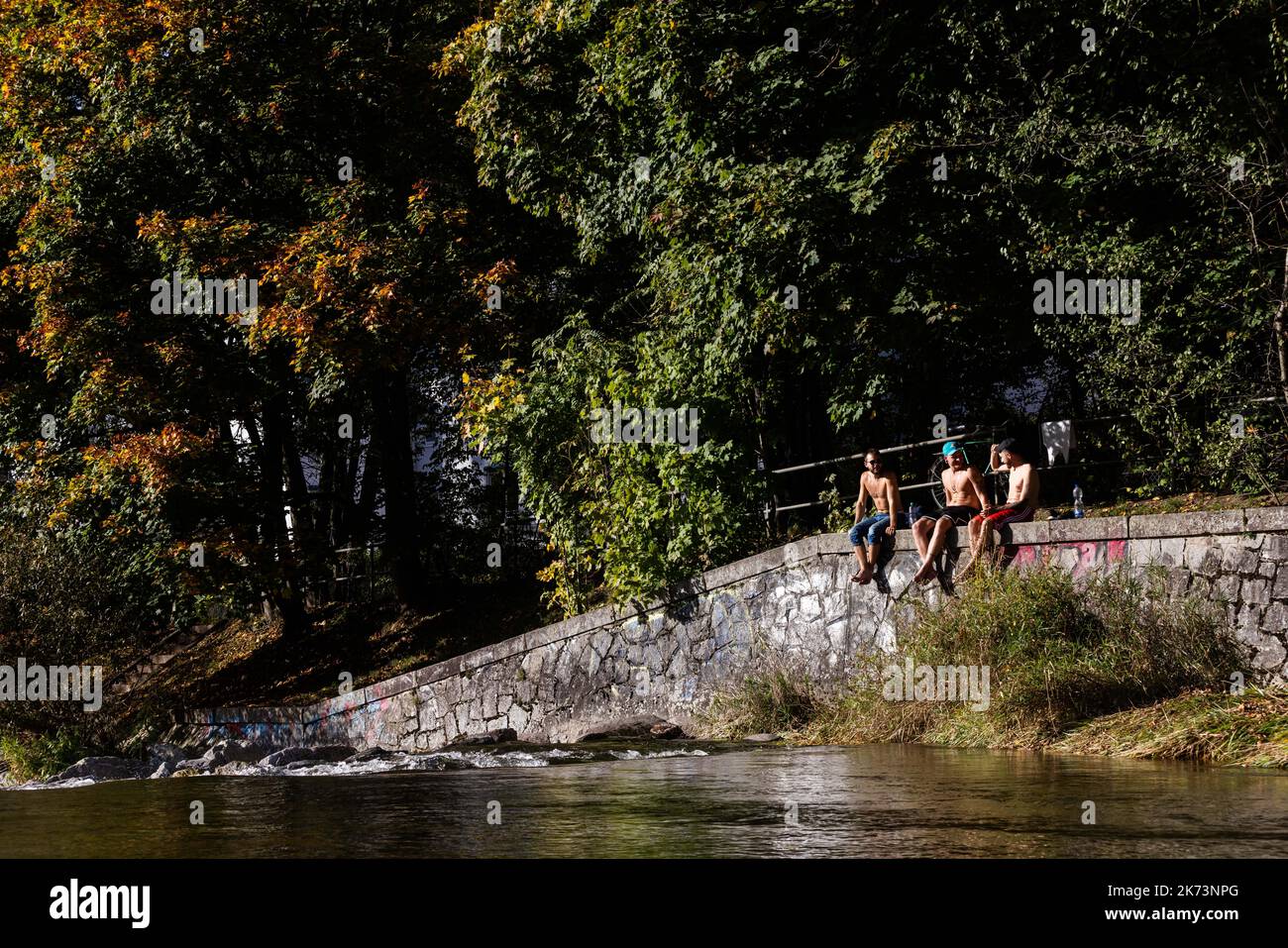 Freiburg, Germany. 17th Oct, 2022. Three men sit bare-chested in the ...