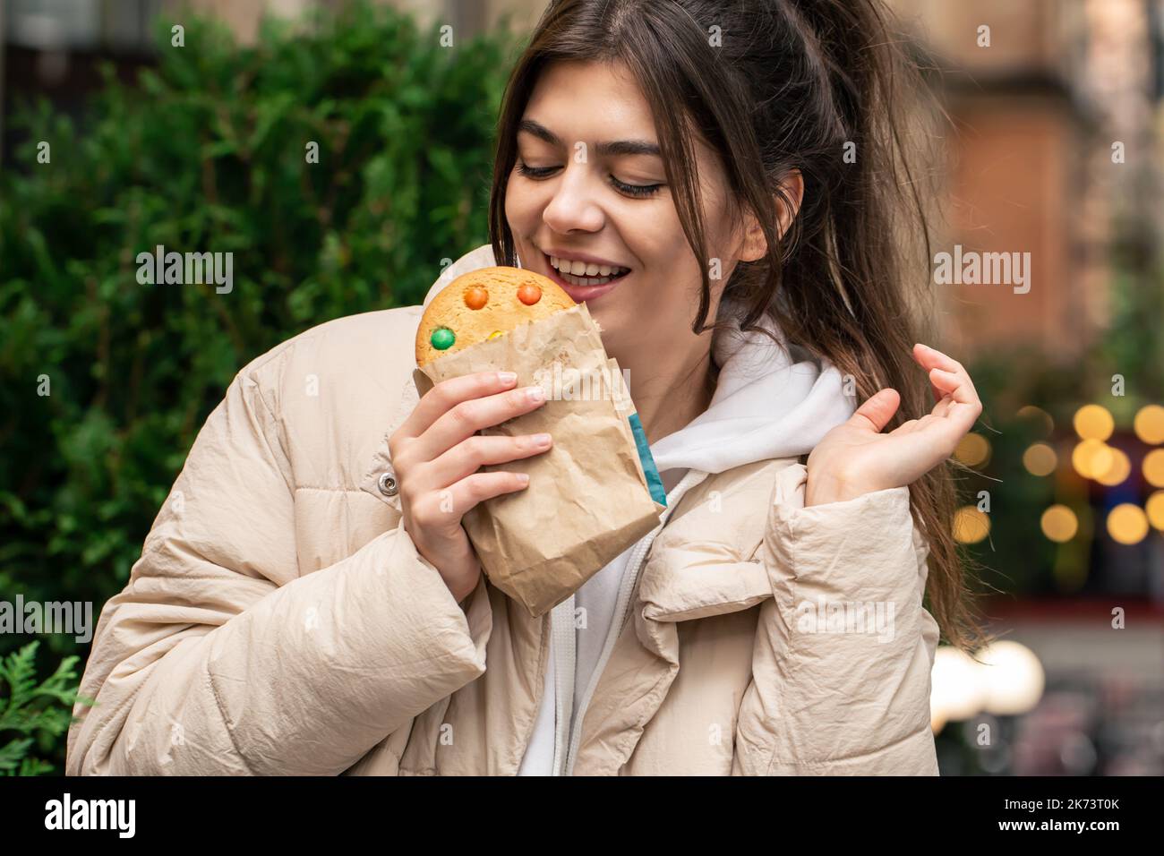 Attractive young woman with a beautiful gingerbread on a walk Stock ...