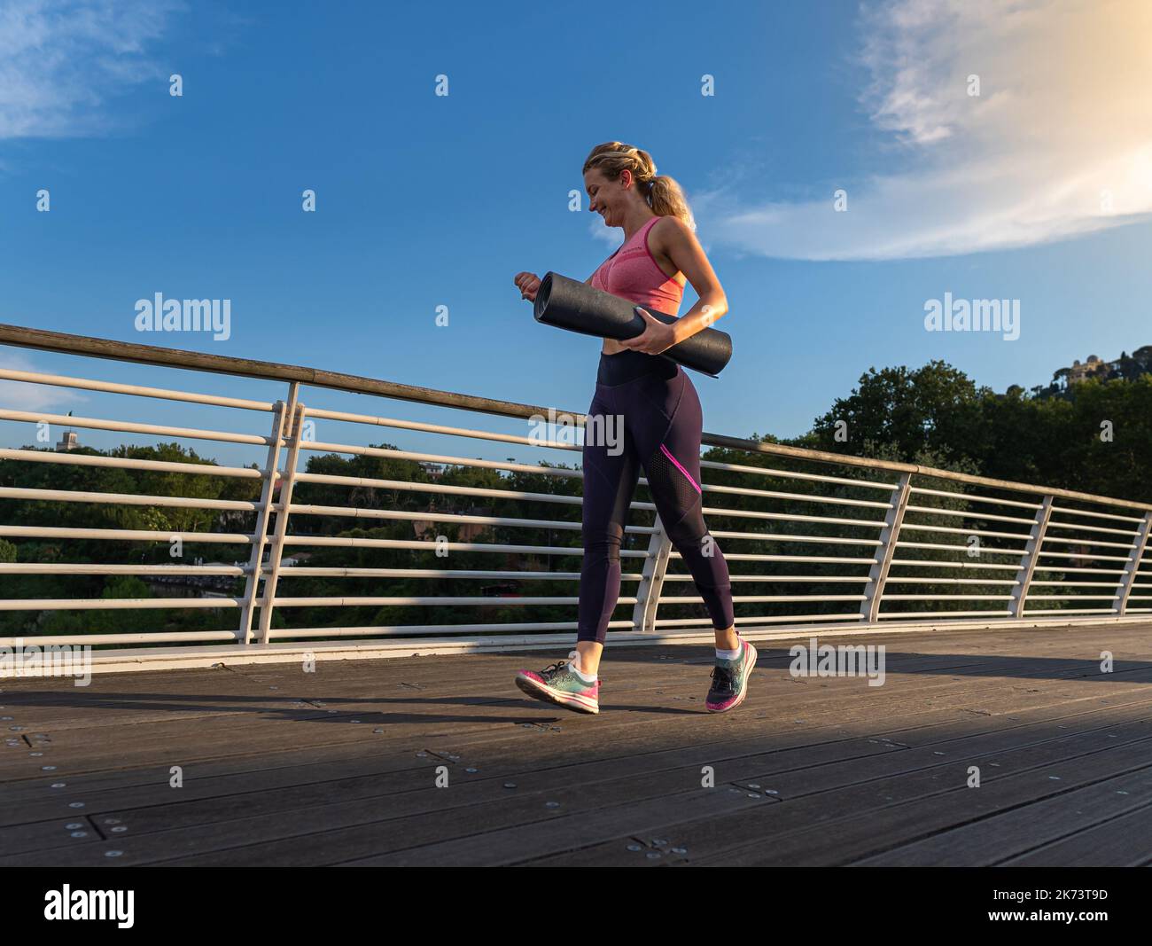 Sporty woman running watches her smartwatch in the city center Stock ...