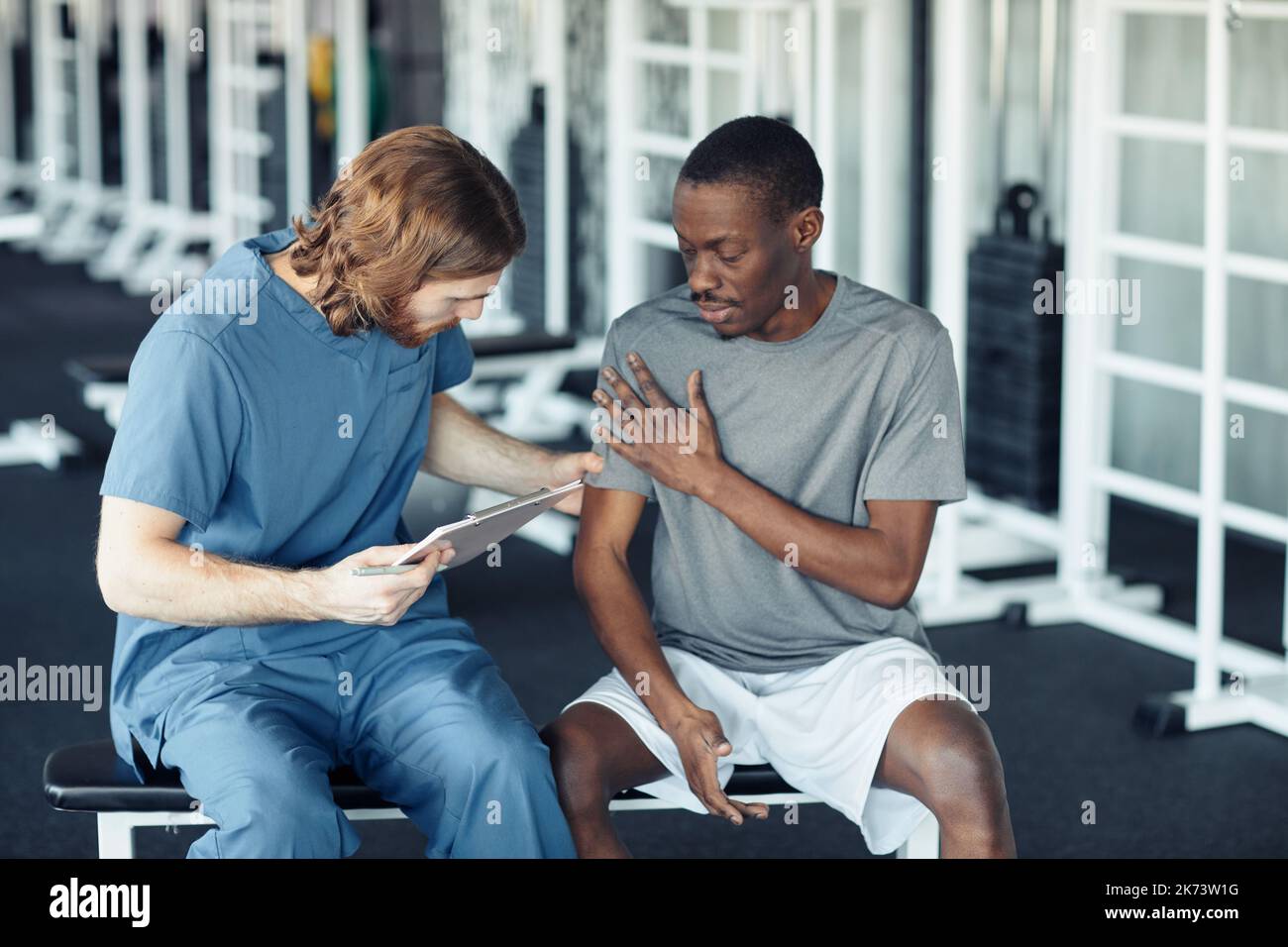 African patient having consultation with doctor before training in ...