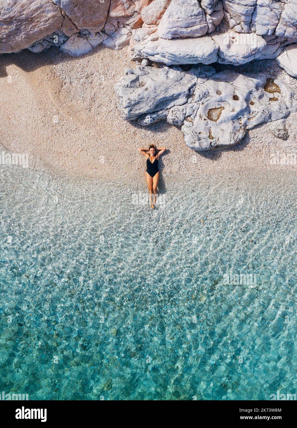 Top view photo showing a woman dressed black swimsuit lying on a white ...