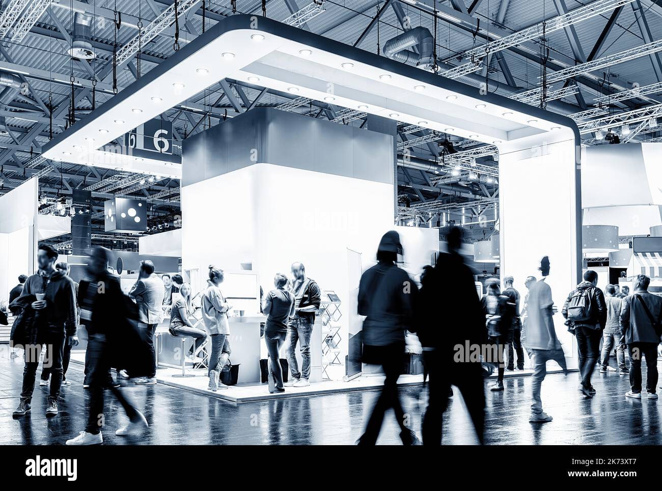 business people walking between trade show booth, with copy space for ...