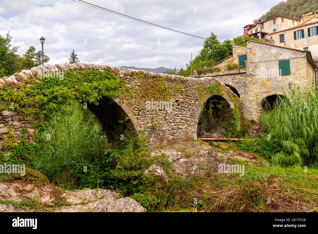 The medieval two arched stone bridge in Molini di Prelà. Prelà is ...