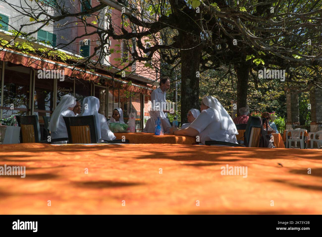 A group of Roman catholic nuns sat around a table chatting, Montallegro ...