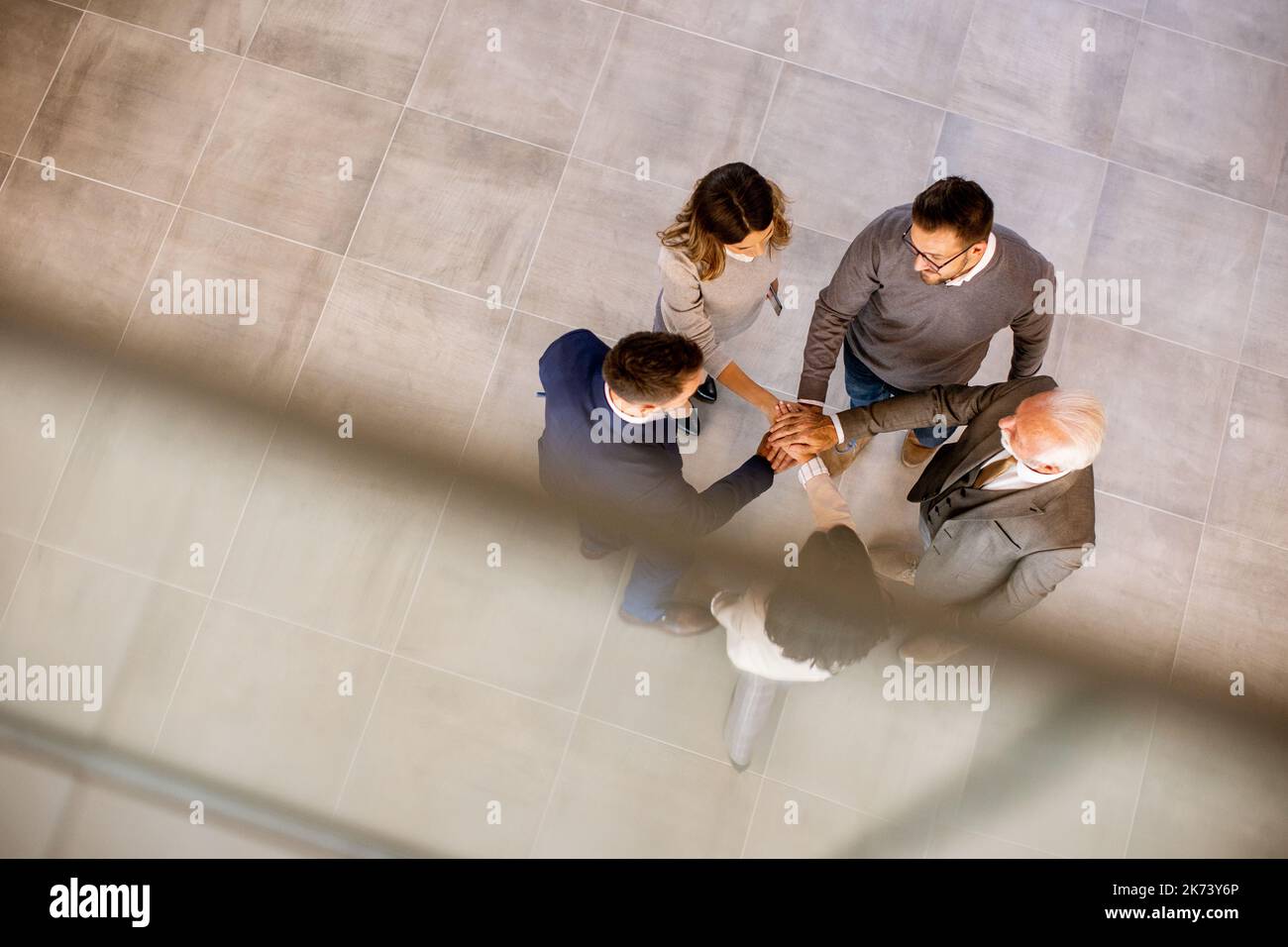 Aerial view at business people team stack hands as unity gesture in the ...