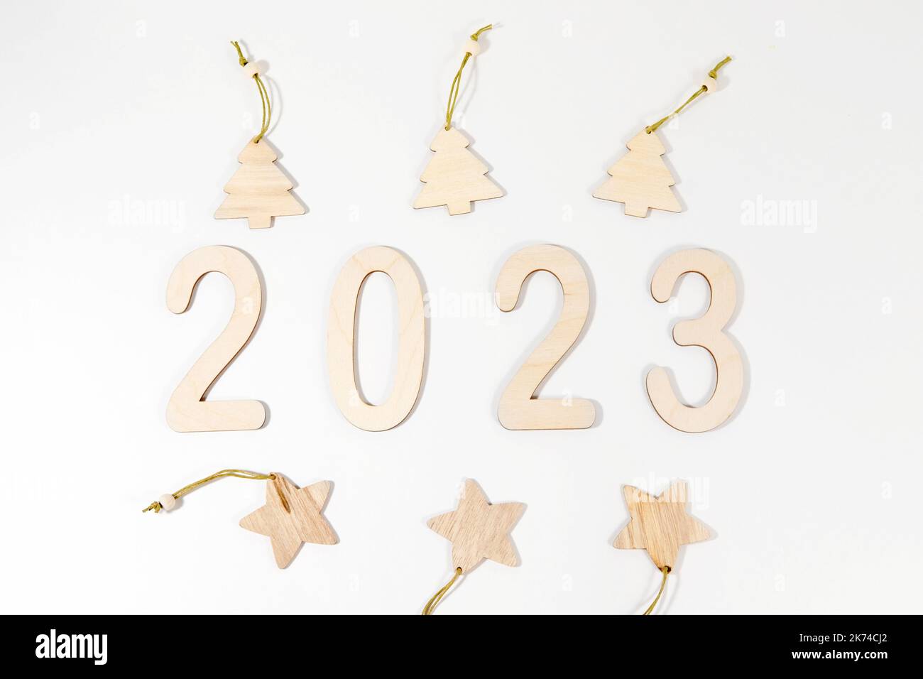 Text 2023 from wooden numbers and Christmas eco wooden decorations on a ...