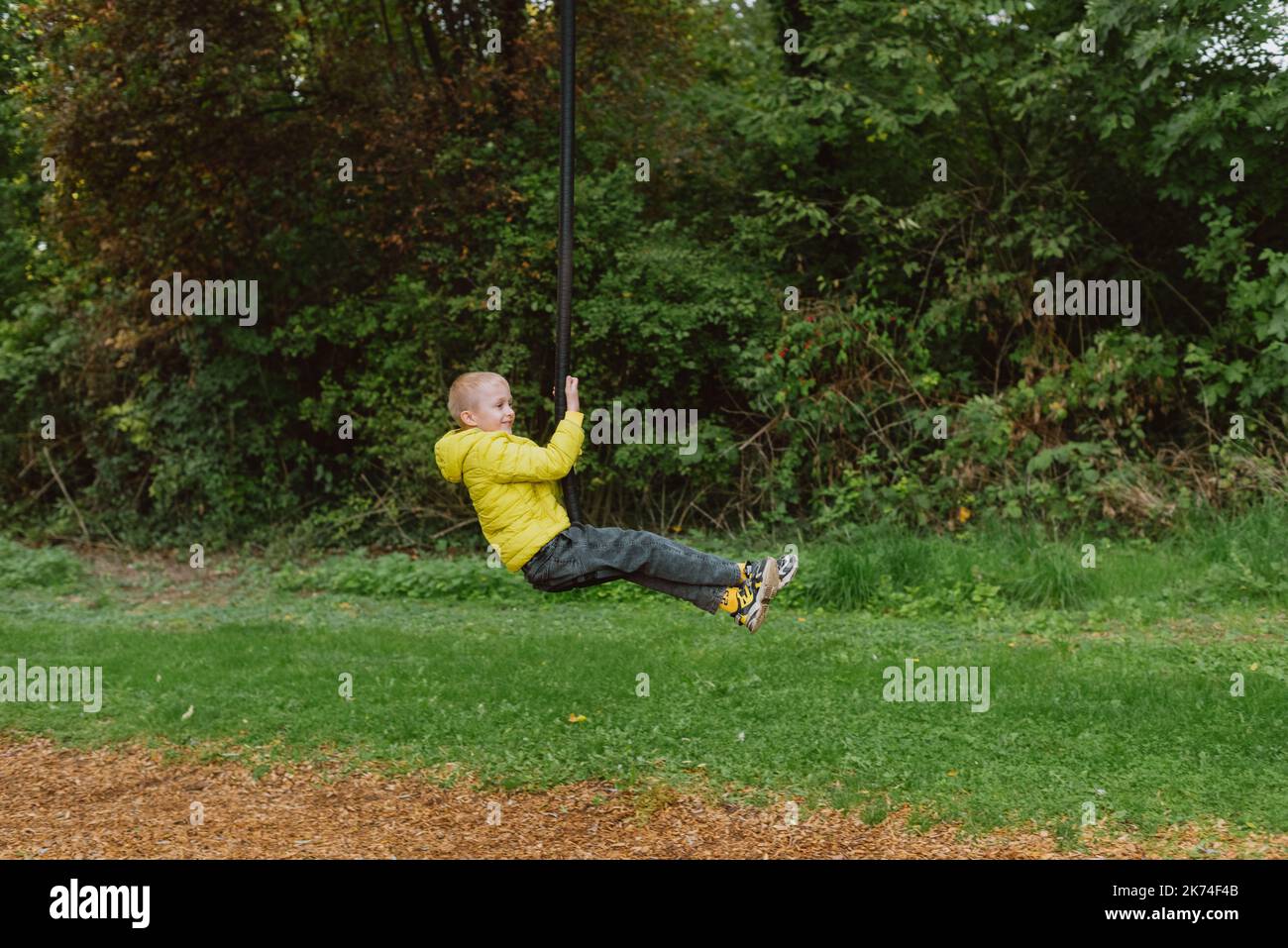 Kid Bungee jumping in the Autumn Forest Stock Photo - Alamy