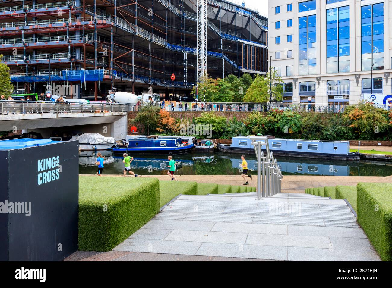 Green steps at granary square and joggers on the towpath of Regents ...