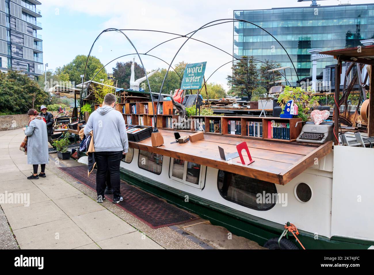 A customer browsing at Word On The Water, aka The London Bookbarge, a ...