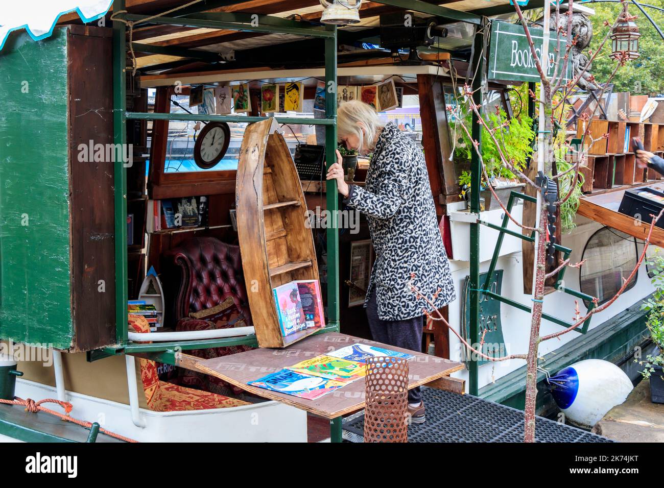 A woman enters Word On The Water, aka The London Bookbarge, a floating ...