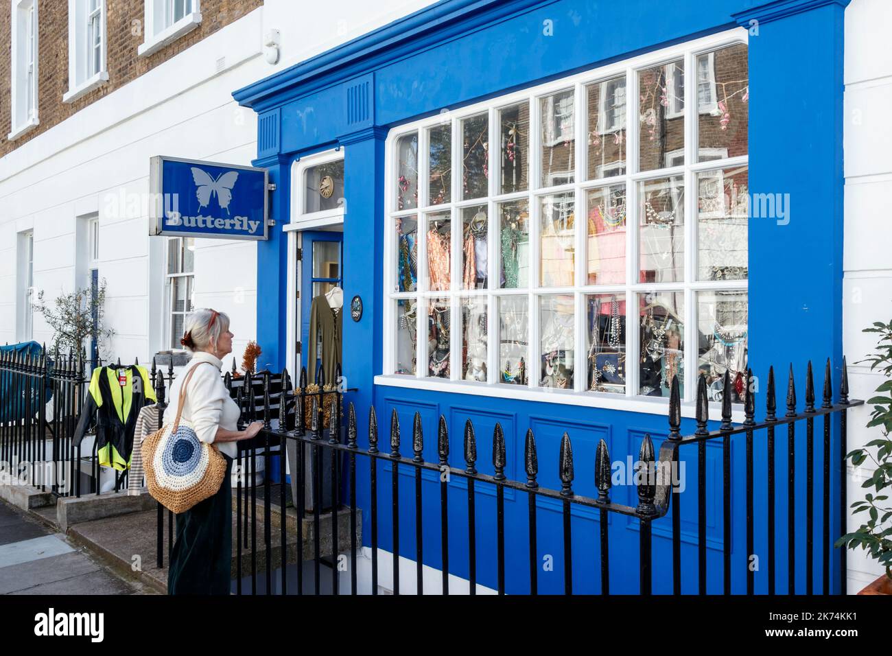 A woman browses the window of Butterfly, a ladies' clothes shop in ...