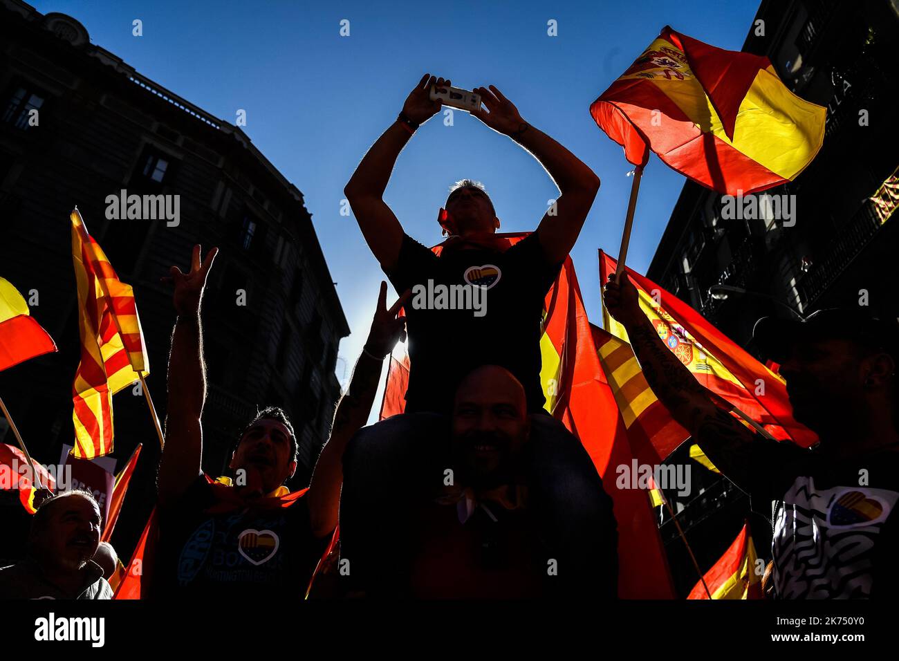 Thousands of people protest with Catalonian and Spanish flags against ...