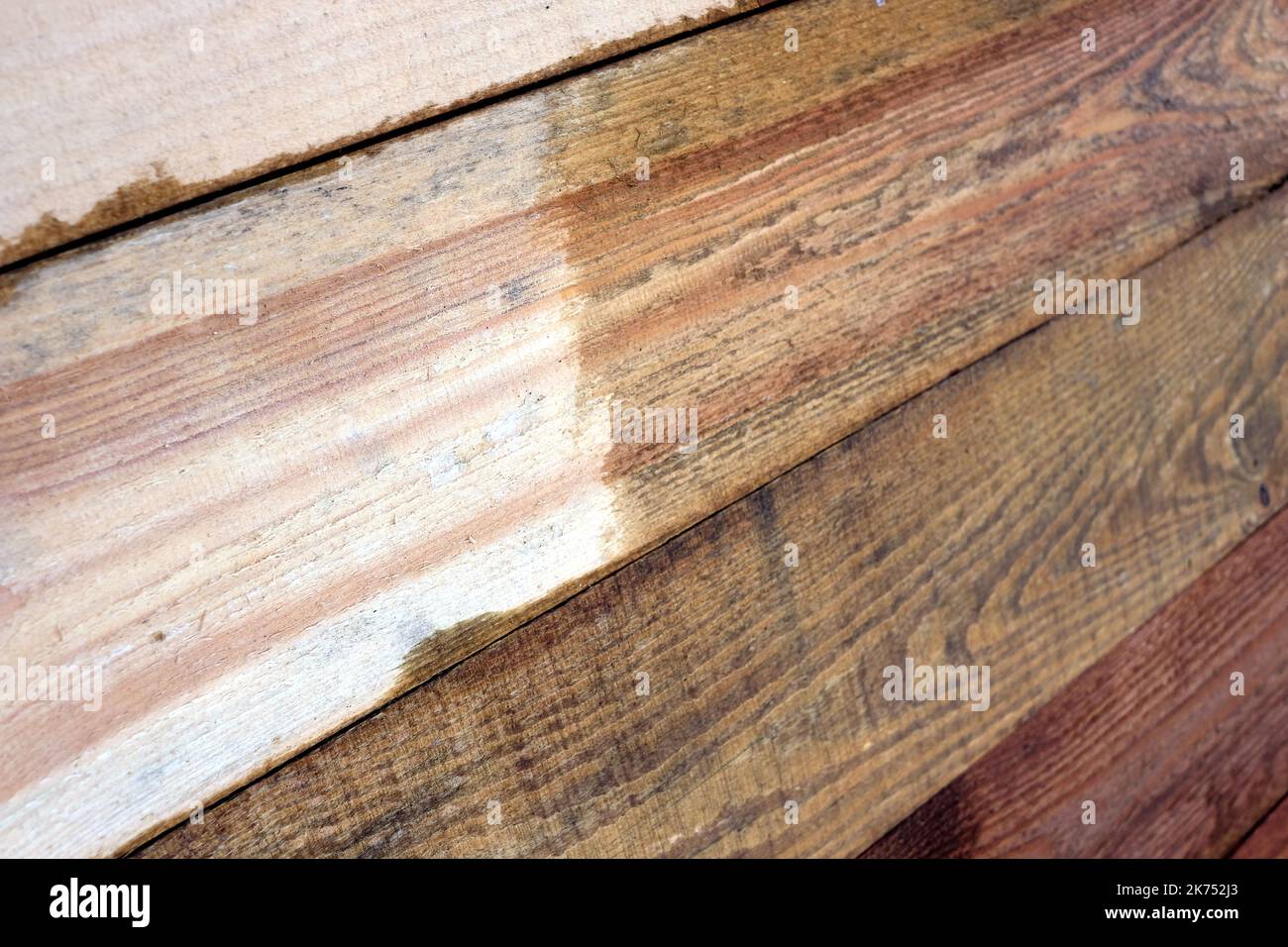 Repair of wooden wall by boards painting close up side view Stock Photo ...