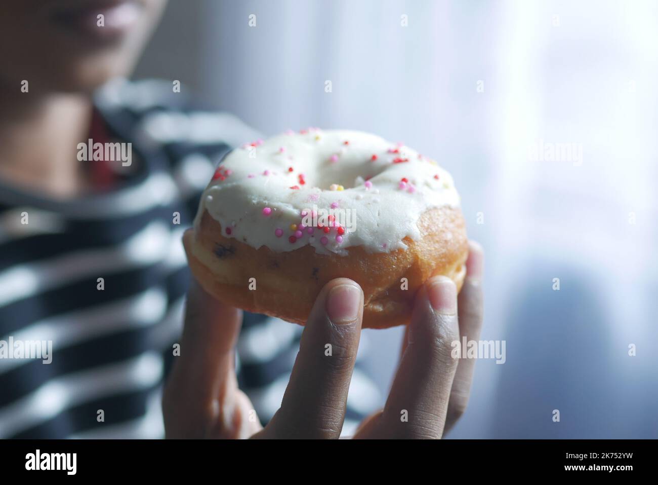 Young man eating donut hi-res stock photography and images - Alamy