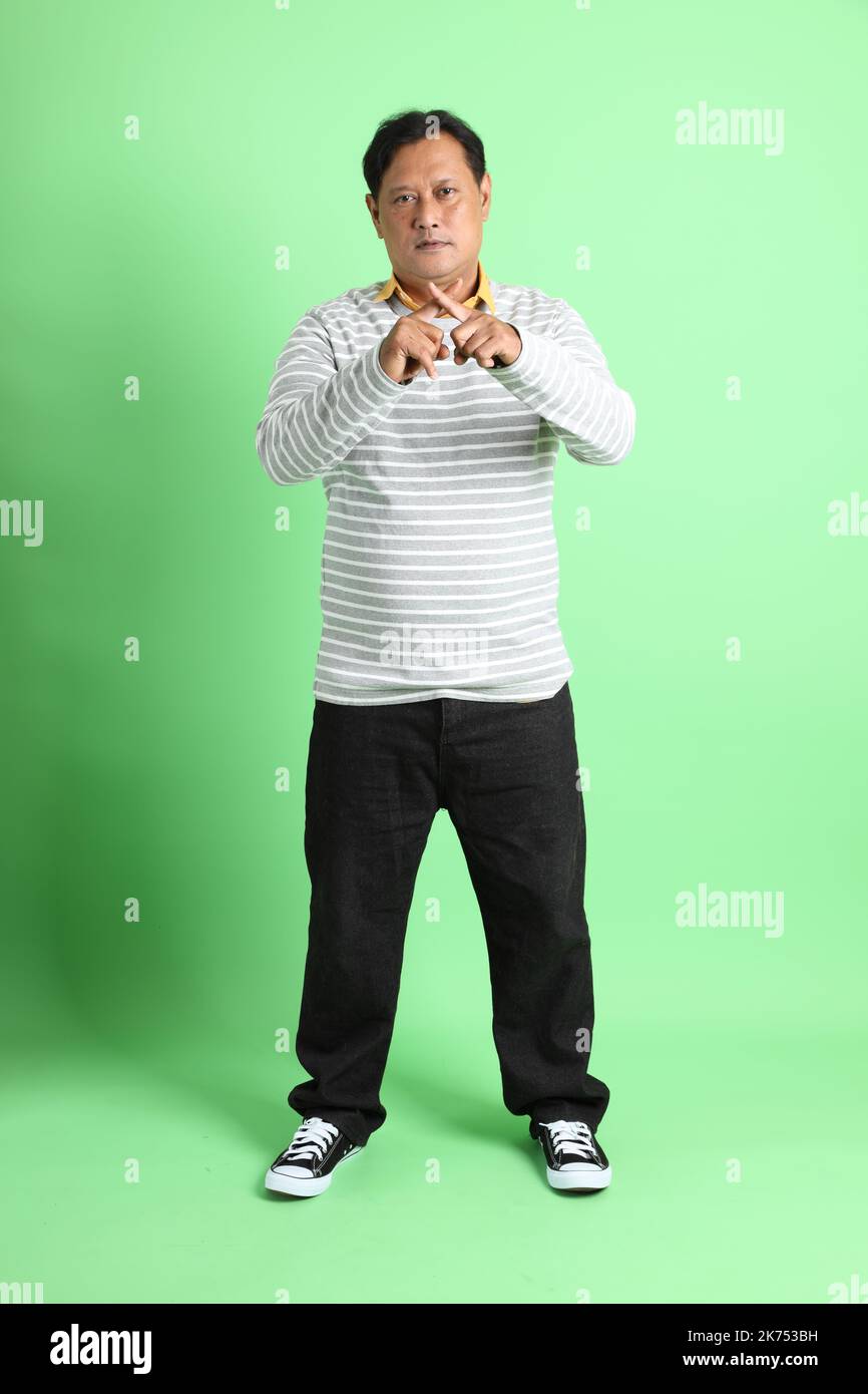 The 40s adult overweight Asian man standing on the green background ...