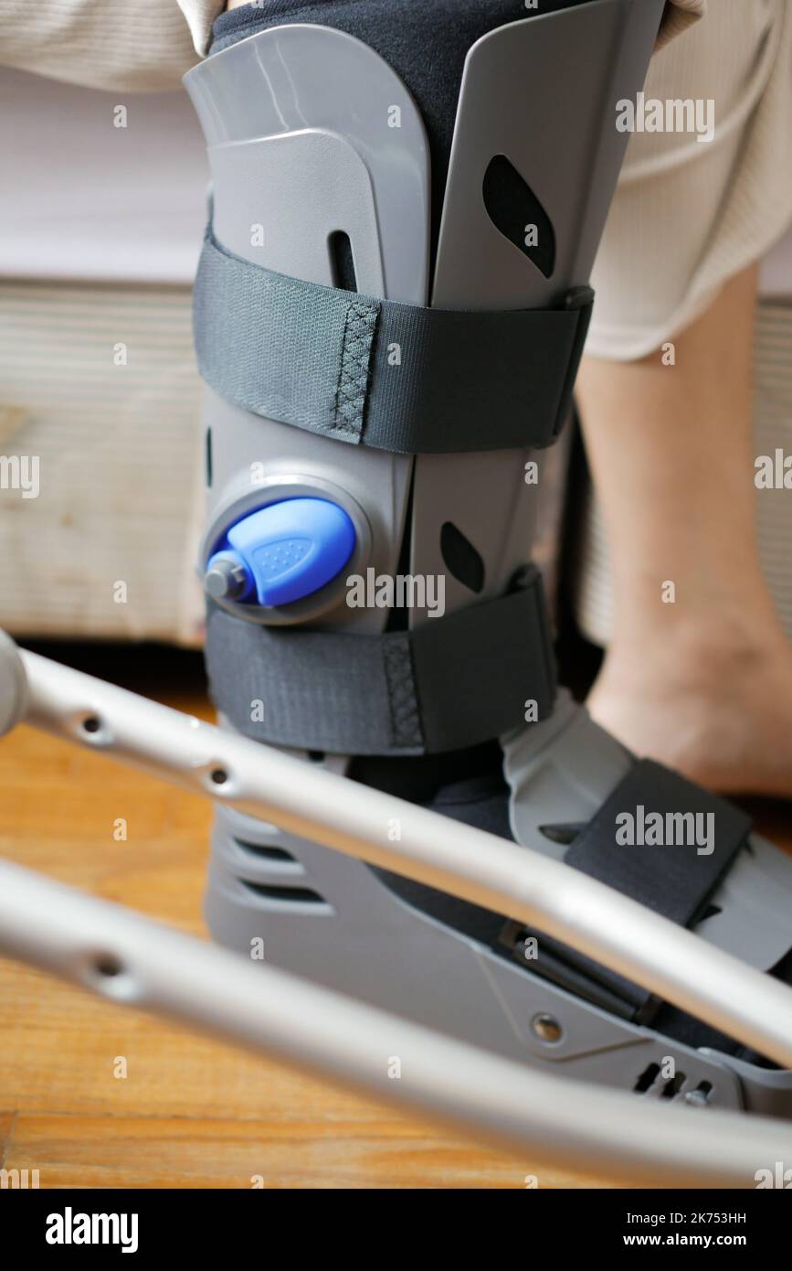 women broken feet with a grey plastic boot ankle brace injury ...