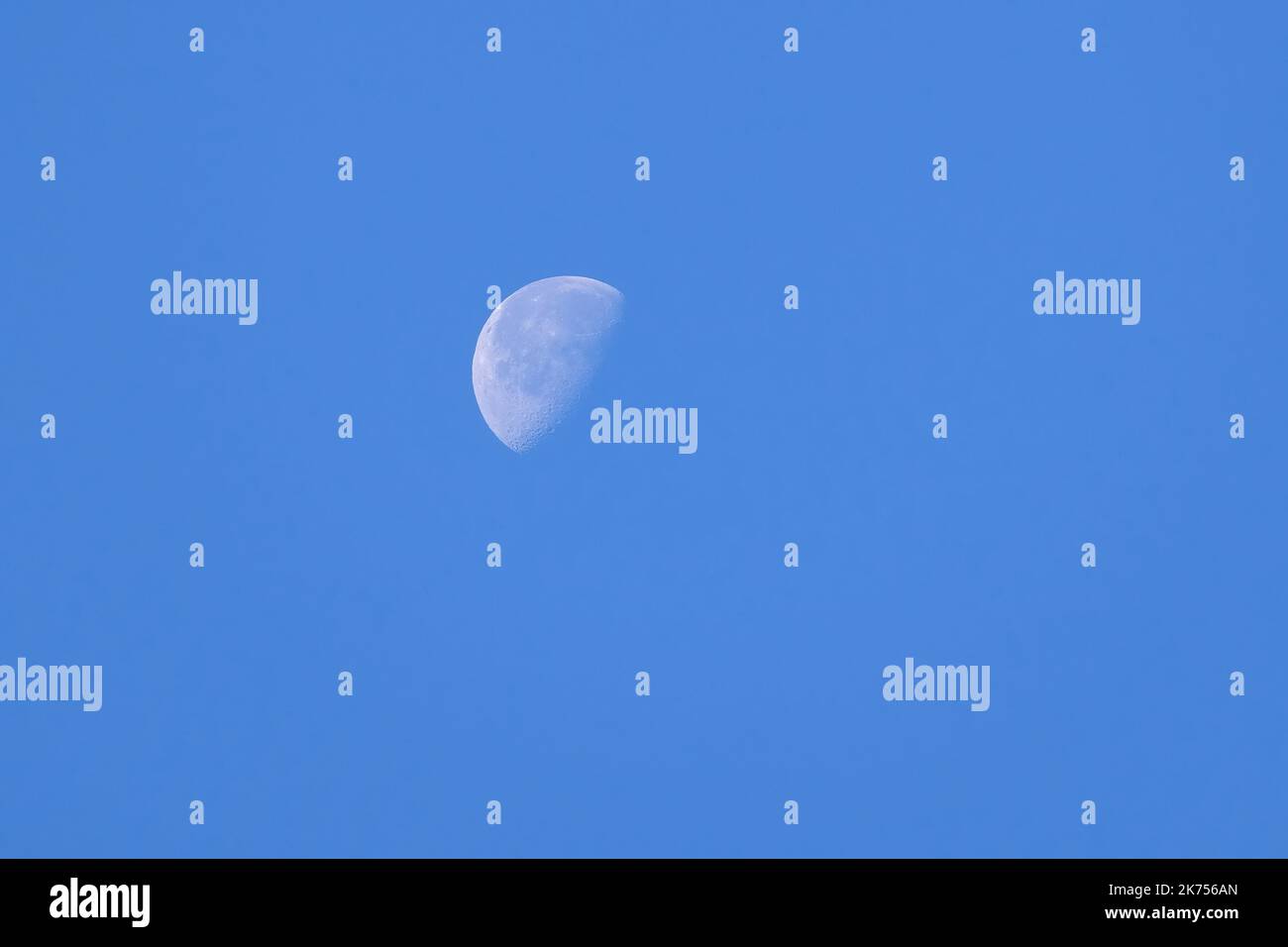 Beautiful day sky landscape with waning moon far on clear cloudless ...