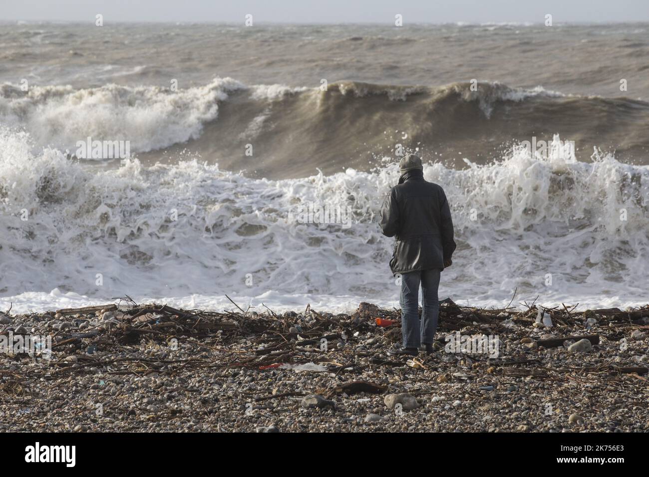 Pedestrians walk around relatively unfazed as they watch the stormy ...