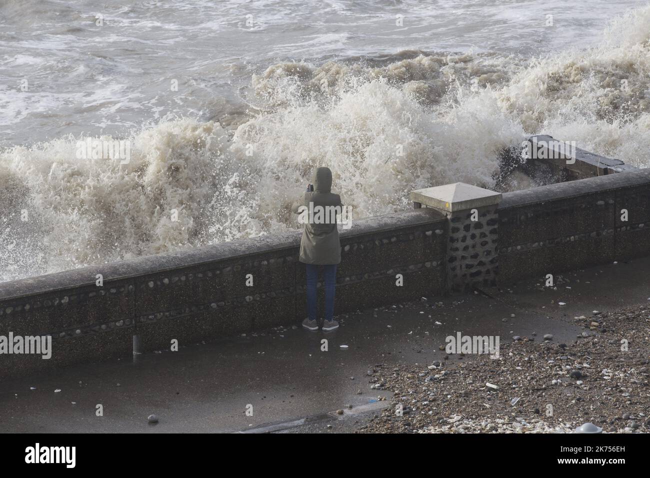 Pedestrians walk around relatively unfazed as they watch the stormy ...