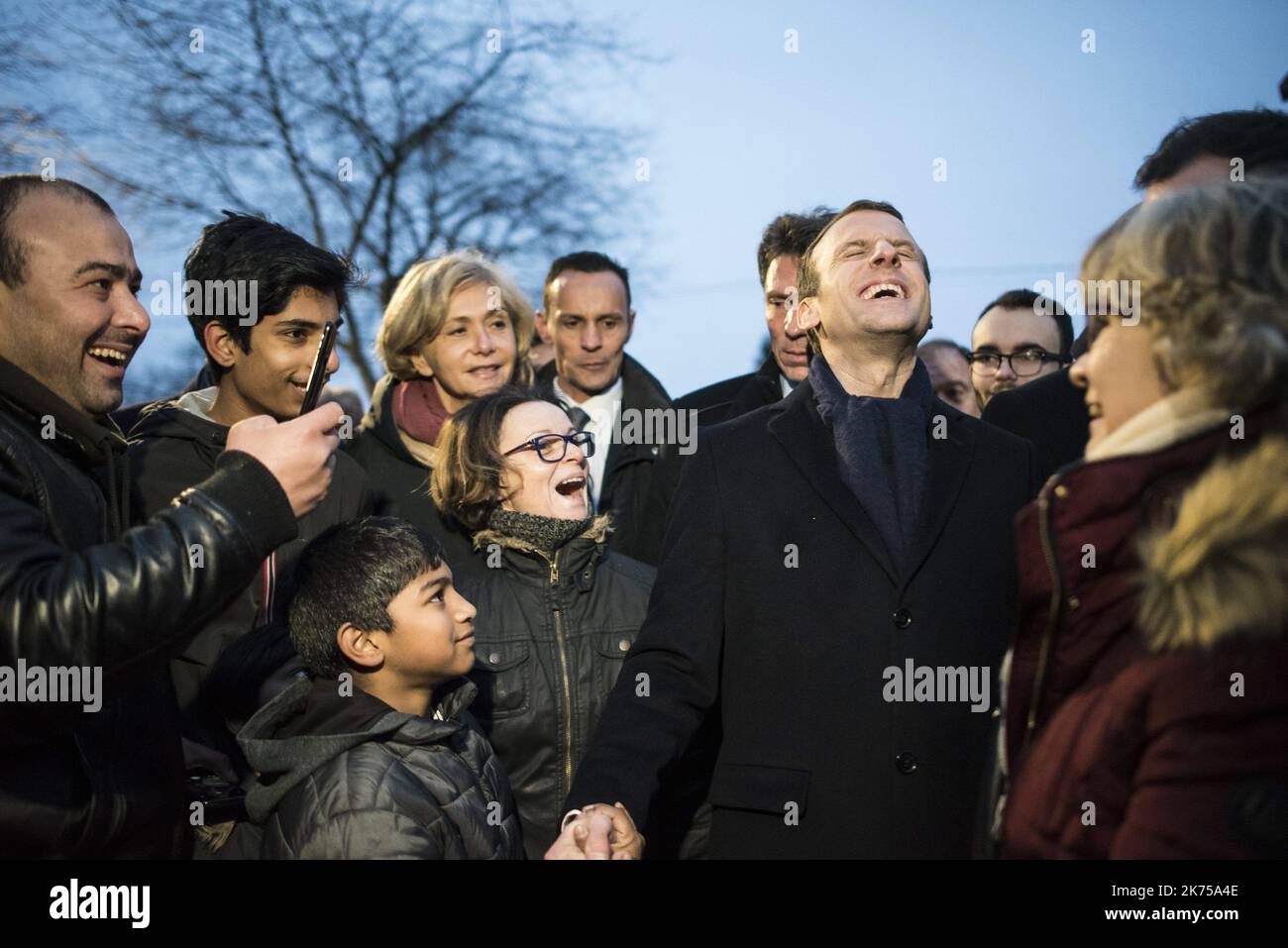 French President Emmanuel Macron speaks with residents as he visits a ...