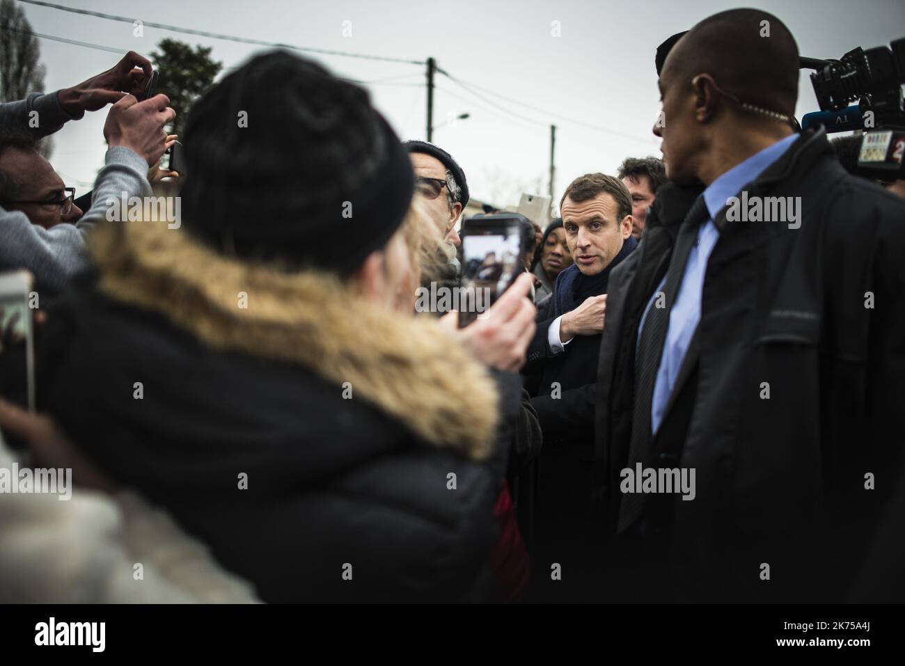 French President Emmanuel Macron speaks with residents as he visits a ...
