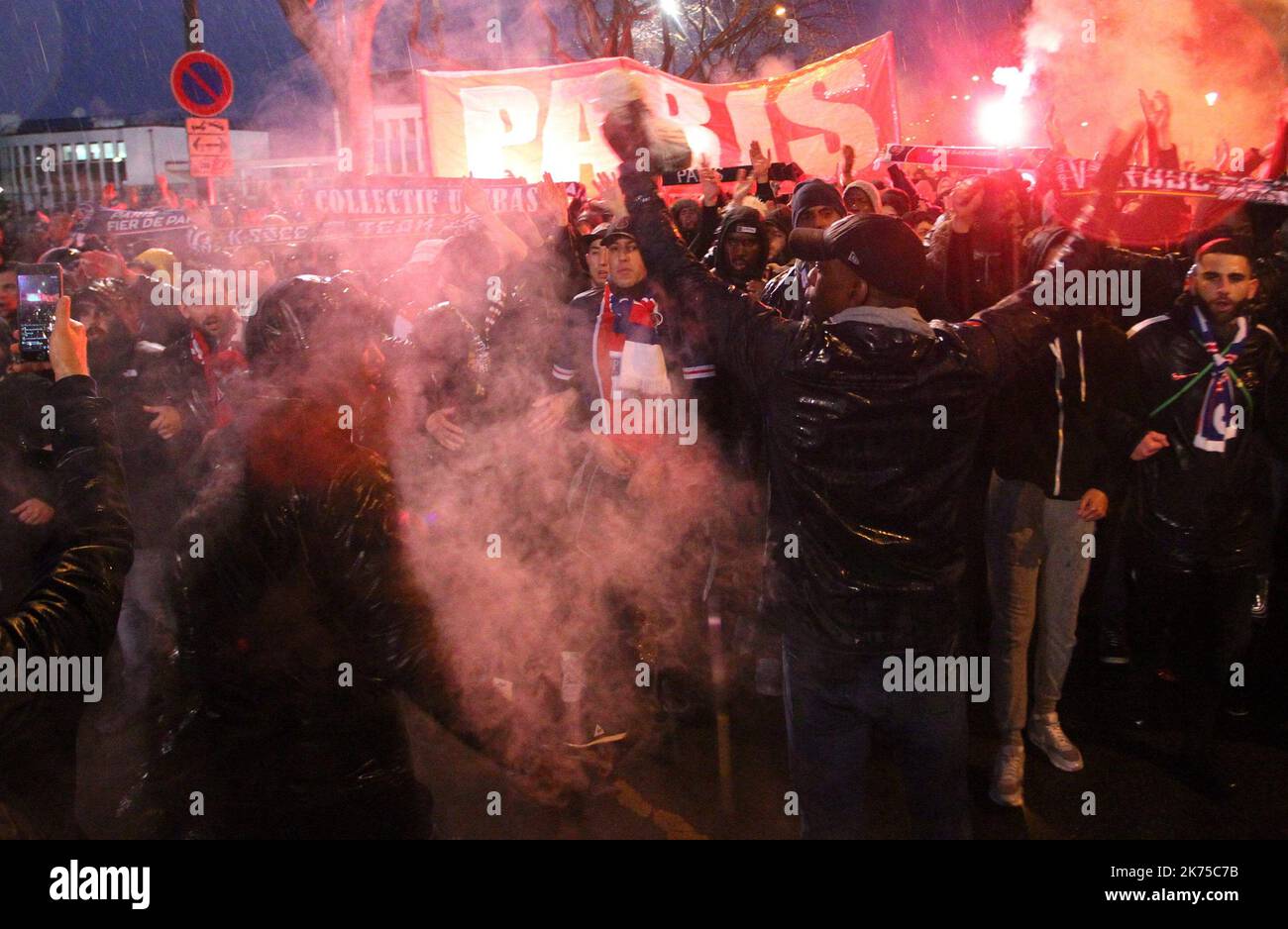 Paris Saint-Germain fans gather outside of the stadium lighting flares ...