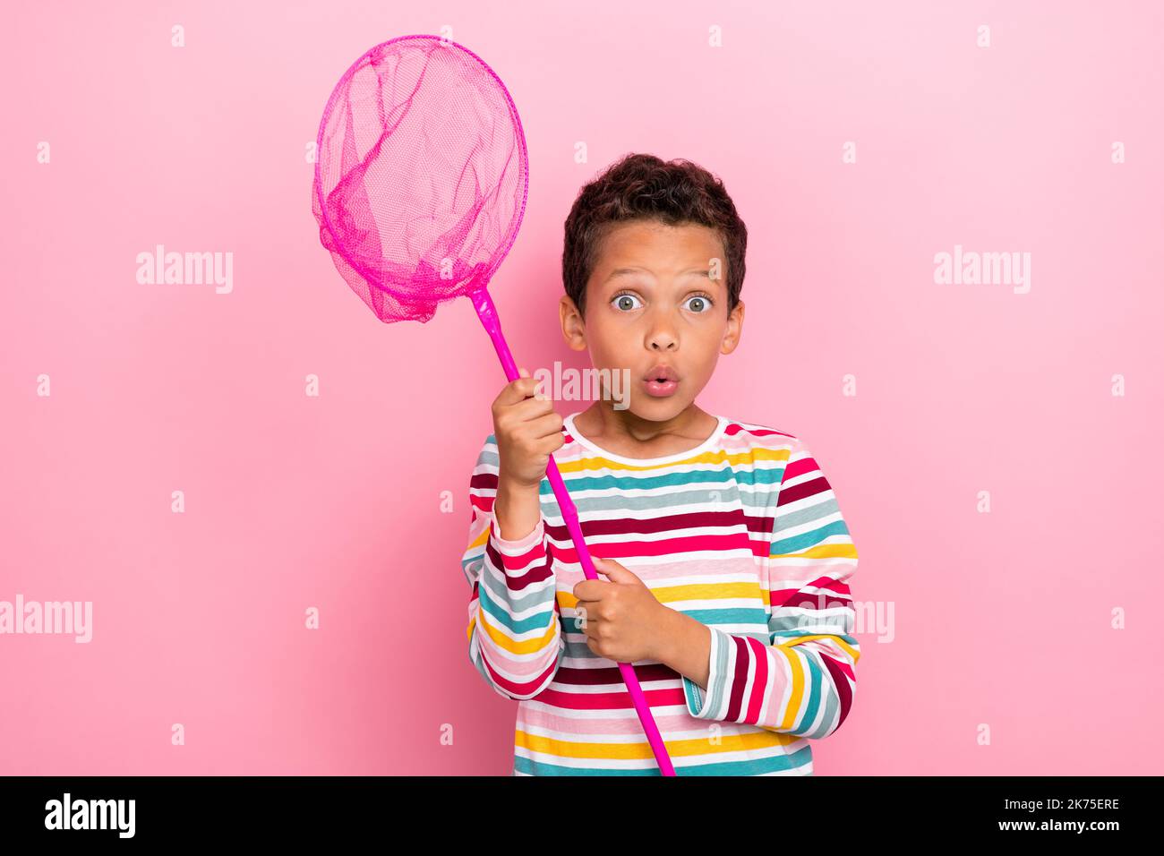 Photo of astonished boy wear striped sweater arm hold net reaction ...