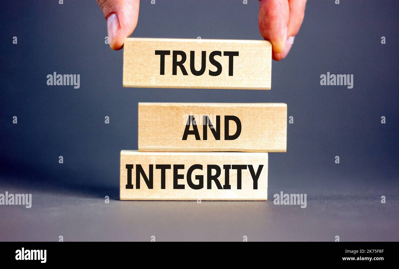 Trust and integrity symbol. Concept words Trust and integrity on wooden ...