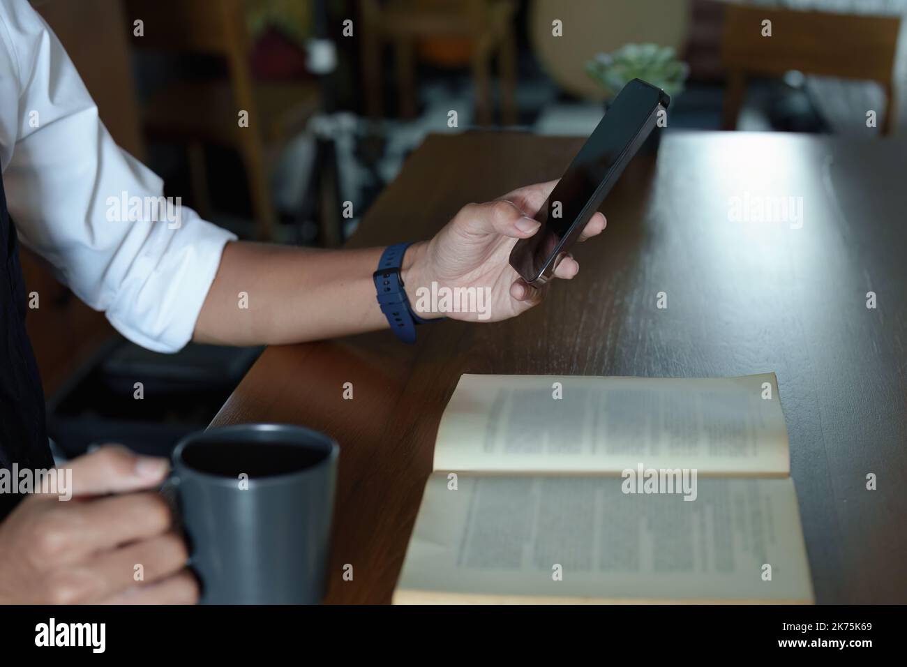 A portrait of a handsome and discreet Asian man sitting at his desk ...
