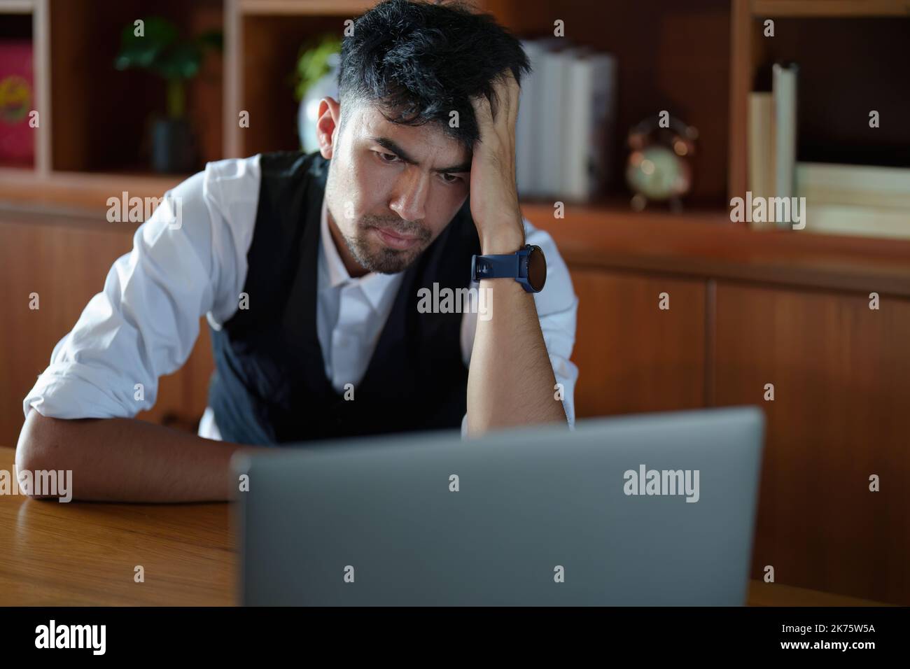 Portrait of an Asian man to be bored from working on a computer Stock ...