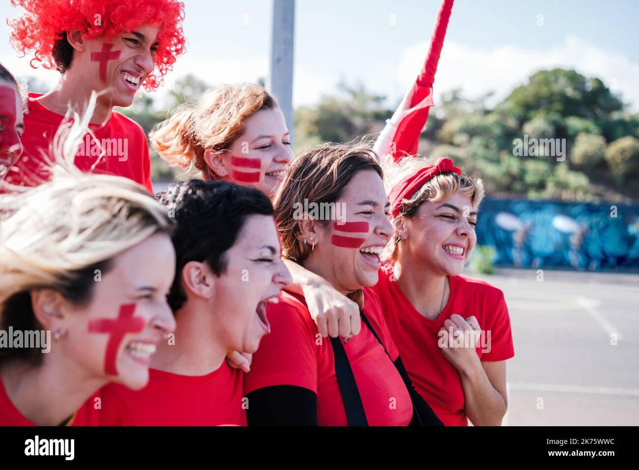 Group of fans celebrating together the victory of their team in the ...