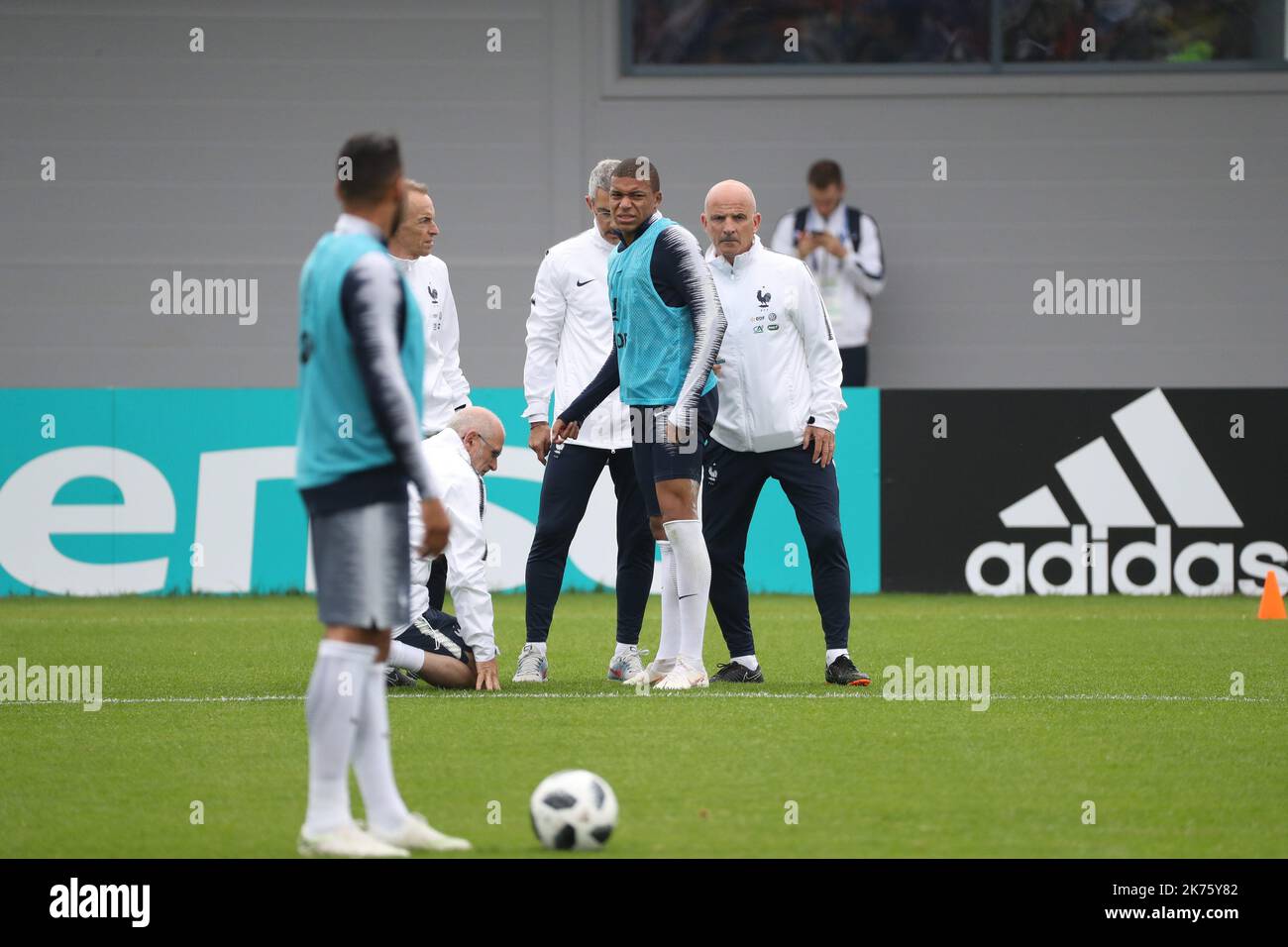 France's Kylian Mbappe lies in pain after a challenge by team-mate Adil ...