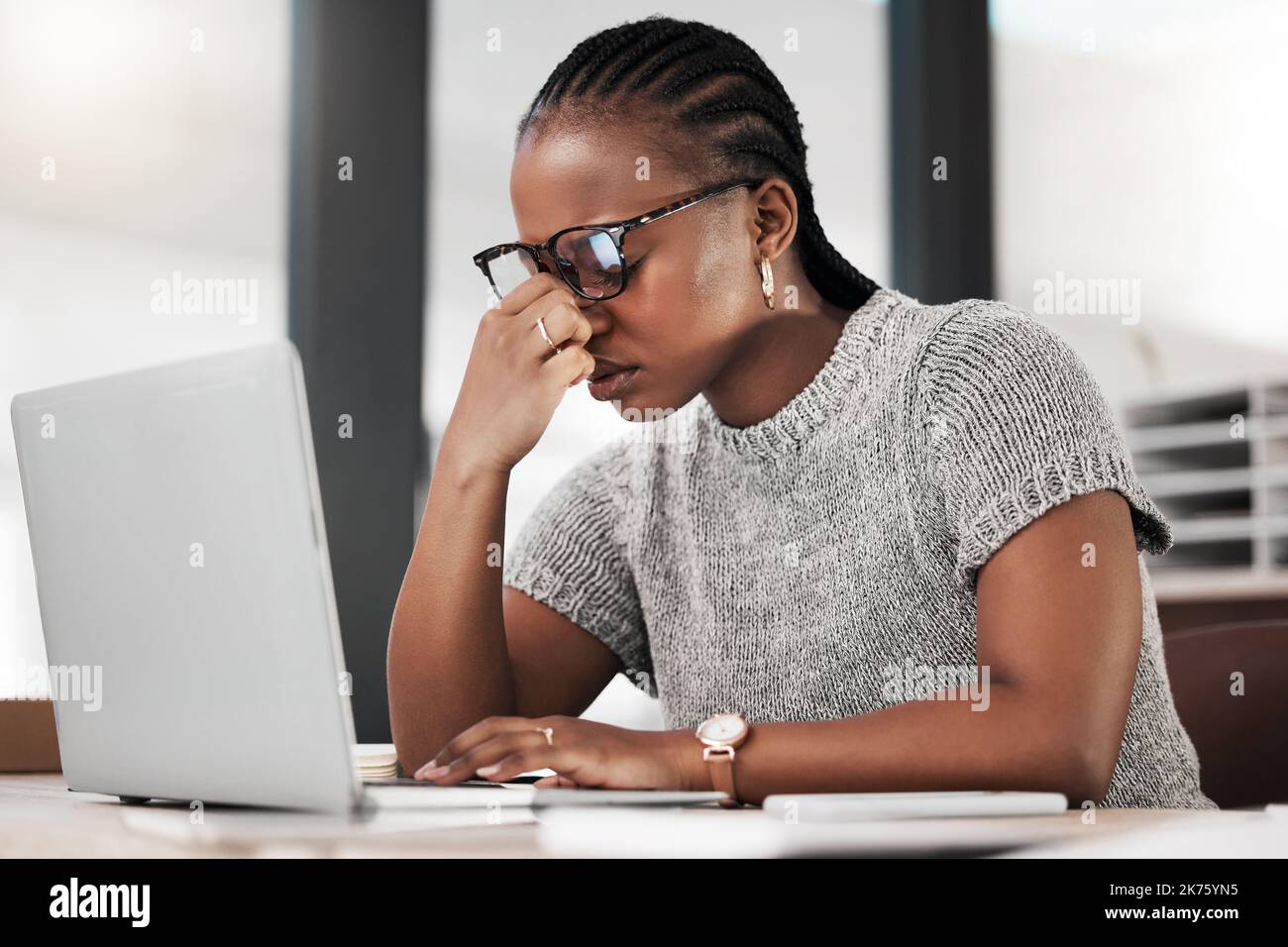 A burdened mind cant make things happen. a young businesswoman looking ...