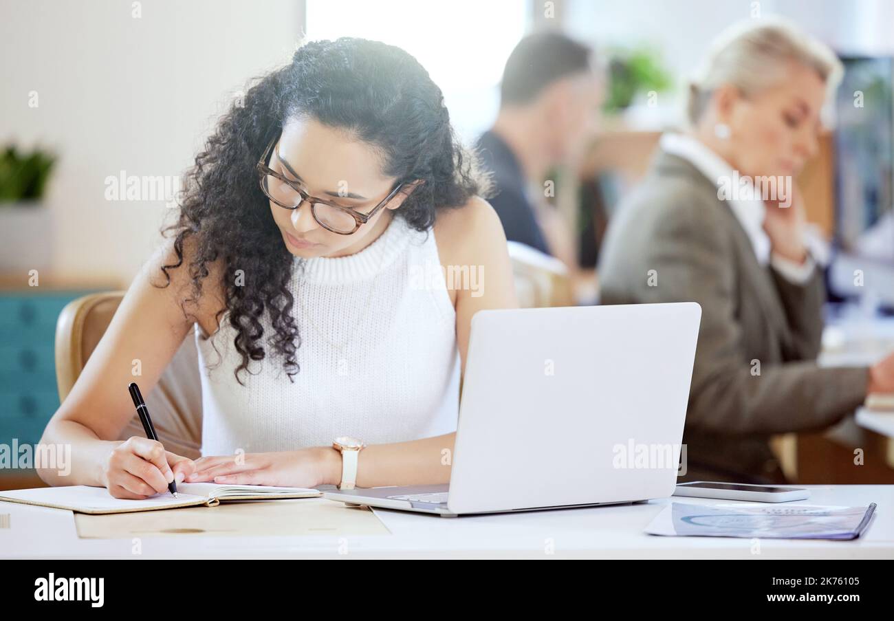 Let me put that in my diary. a young businesswoman writing in a diary ...