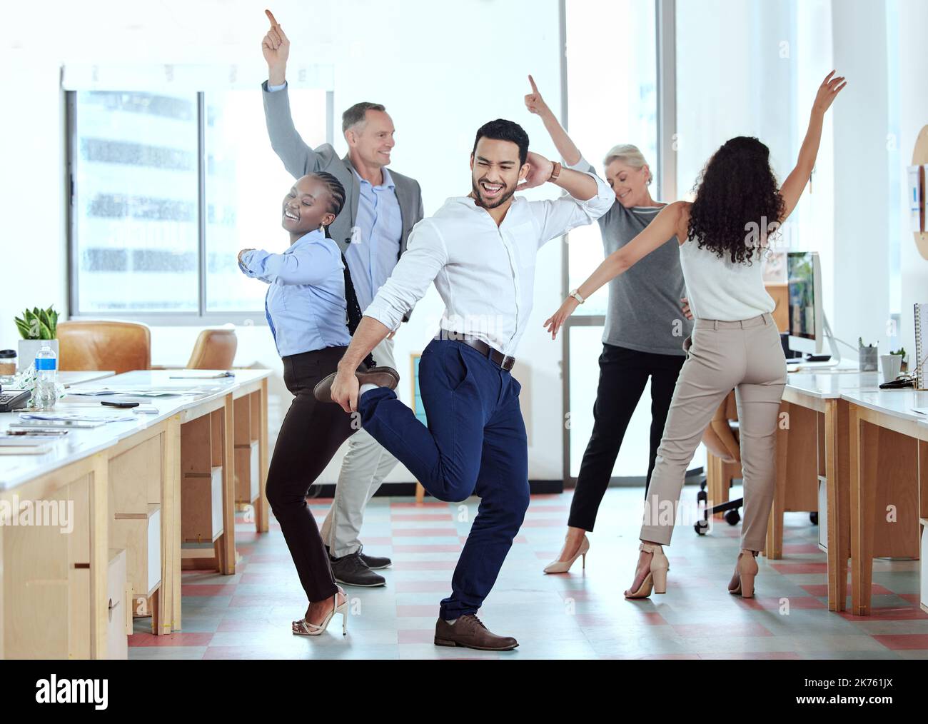 Showing off his moves. a group of businesspeople dancing in an office ...