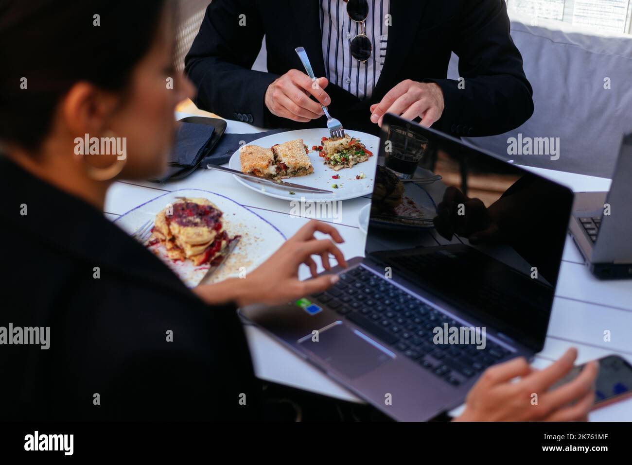 A lovely businesswoman finished with her breakfast and kept working on ...