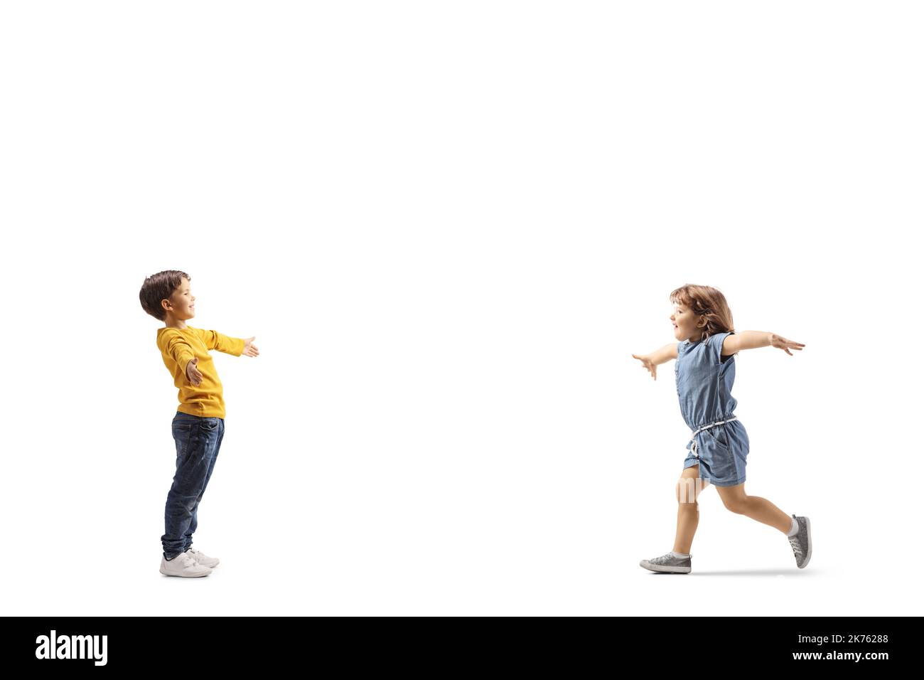 Full length profile shot of a happy little boy waiting to hug a little ...