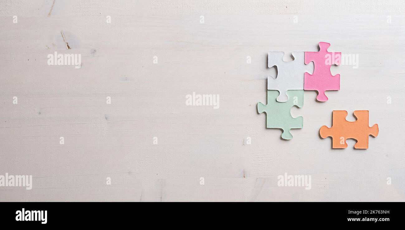 Three colorful blank puzzle pieces matched together with the fourth one ...