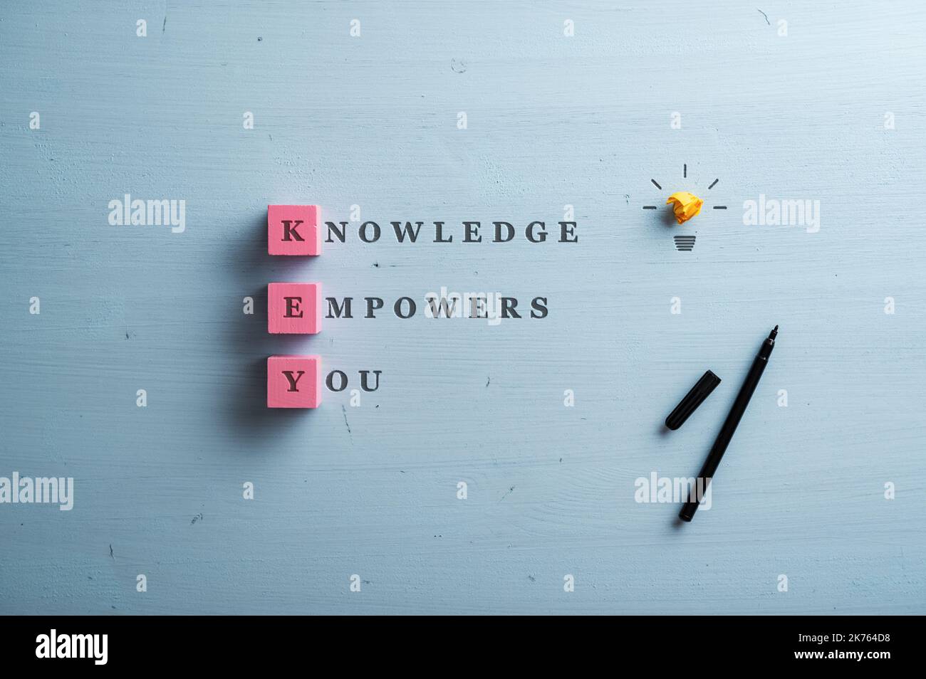 Knowledge empowers you sign written on blue wooden background with the ...
