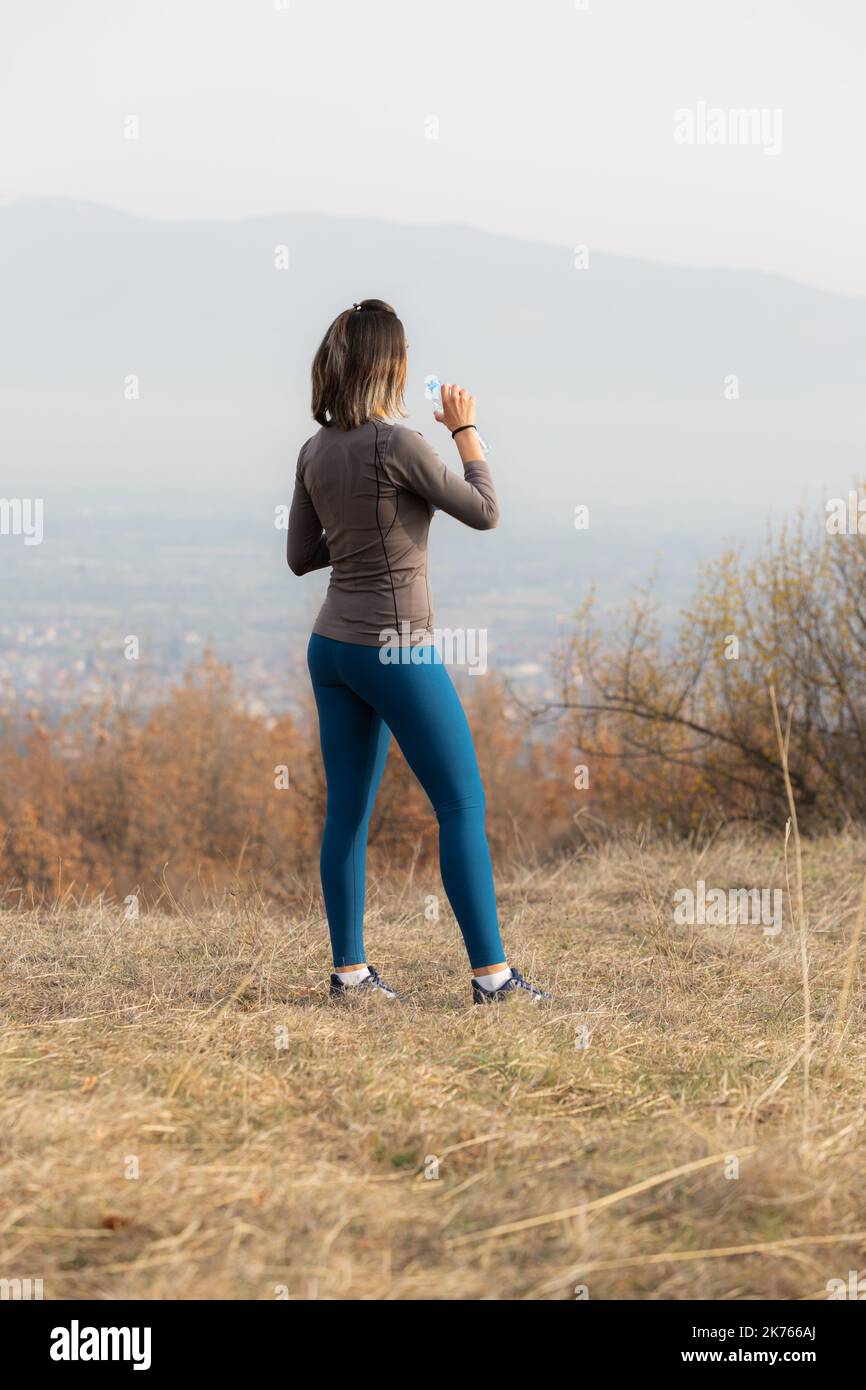 Amazing and active woman is about to drink some water Stock Photo - Alamy