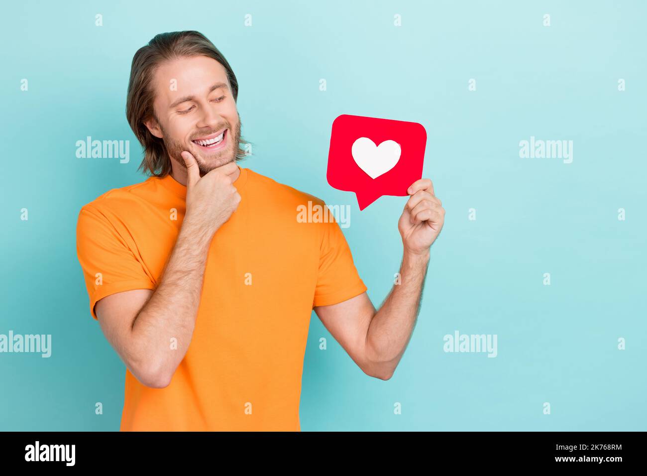 Photo of cute thoughtful man dressed orange t-shirt arm chin holding ...