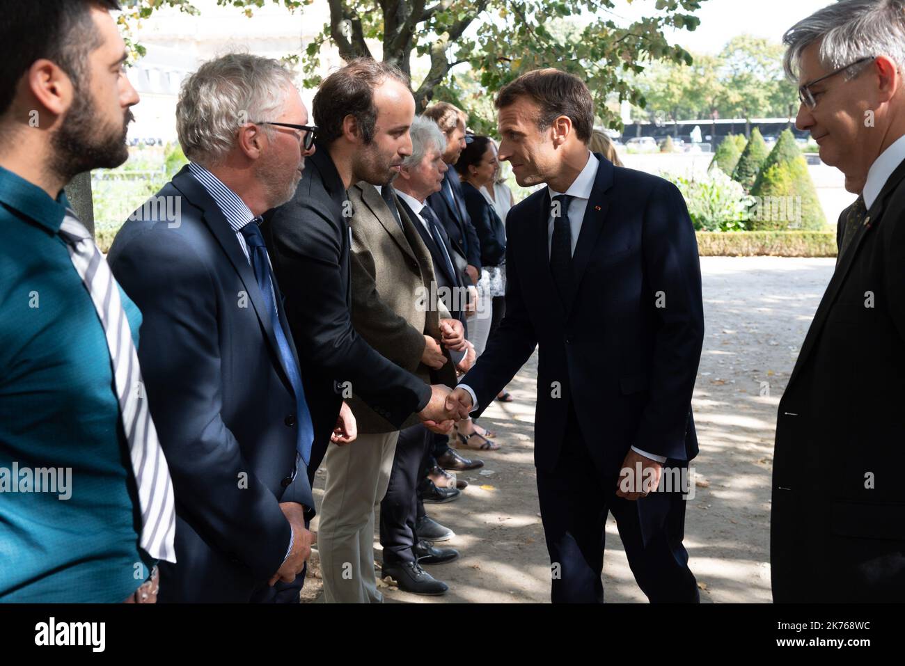 Vice President of the french association Life for Paris Arthur Denouveaux shakes hands with ...