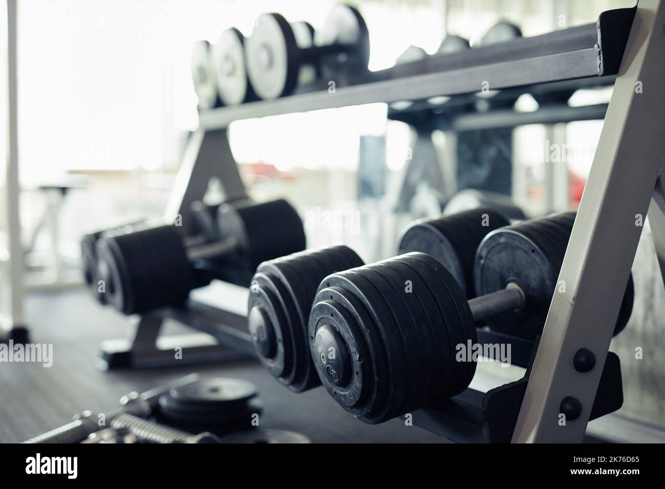 Close-up of heavy barbell for weightlifting on the shelves in sport ...