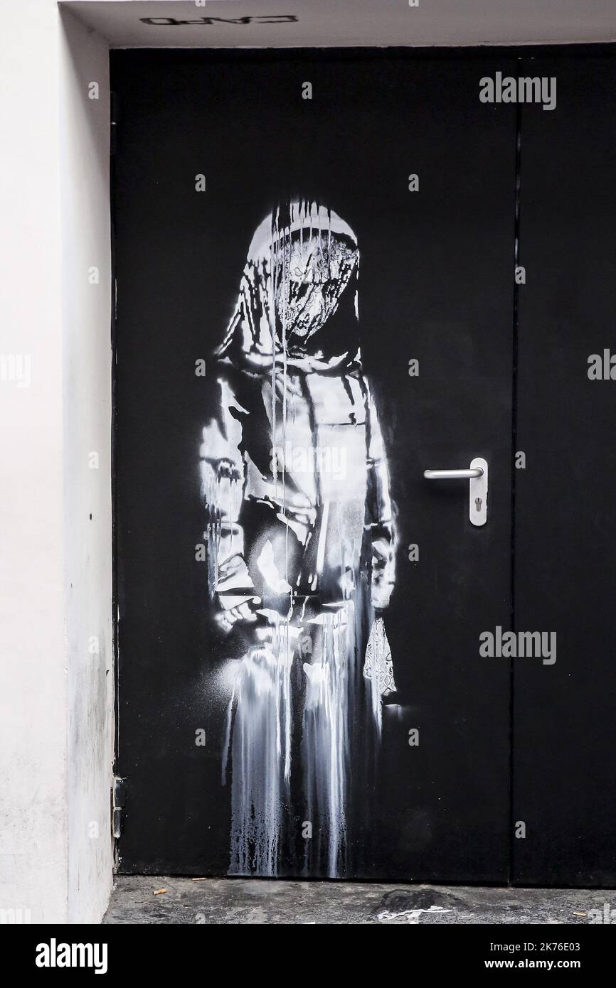 Artwork by street artist Banksy in Paris, on a side street to the ...